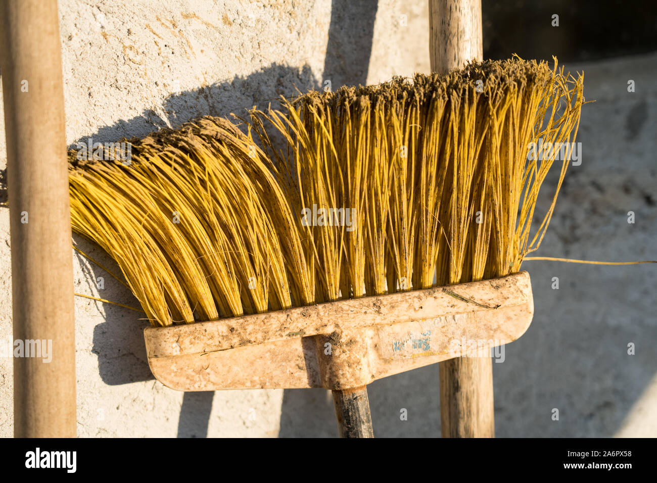 Old broom leaning on the wall Stock Photo - Alamy
