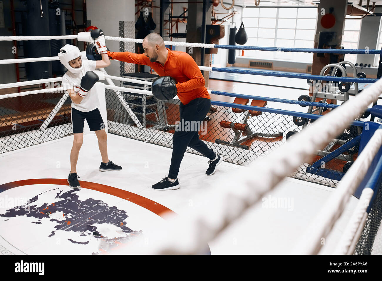young professional talented trainer learning a boy to protect himself ...