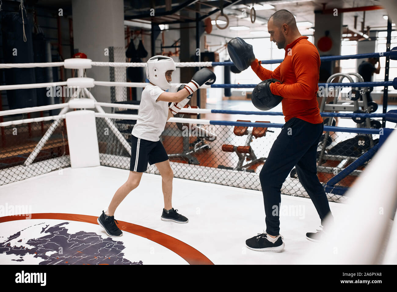 little ambitious motivated boy enjoying boxing process, full length ...