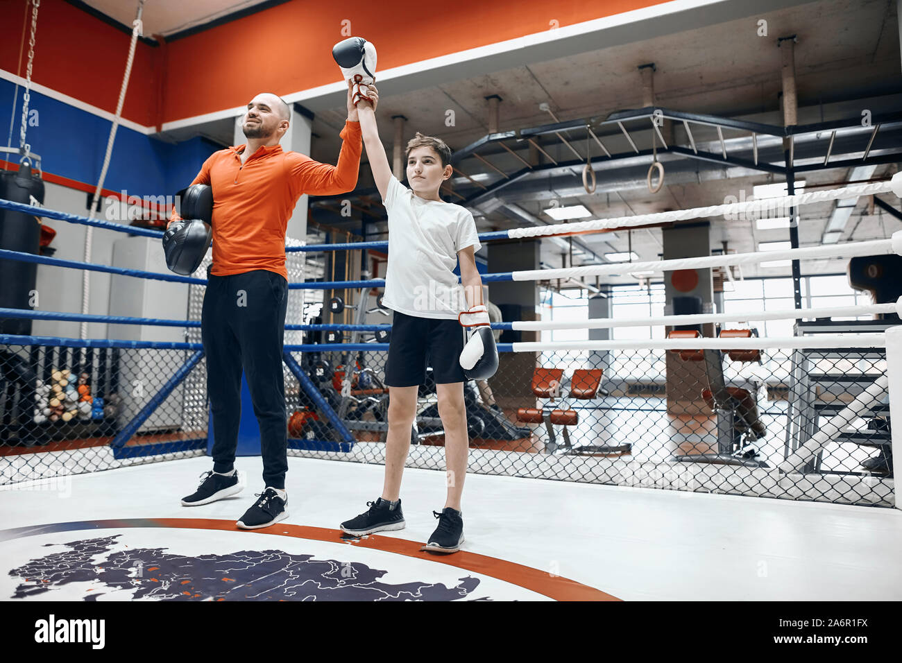 young positive man raising boy's arm who was the best during the ...