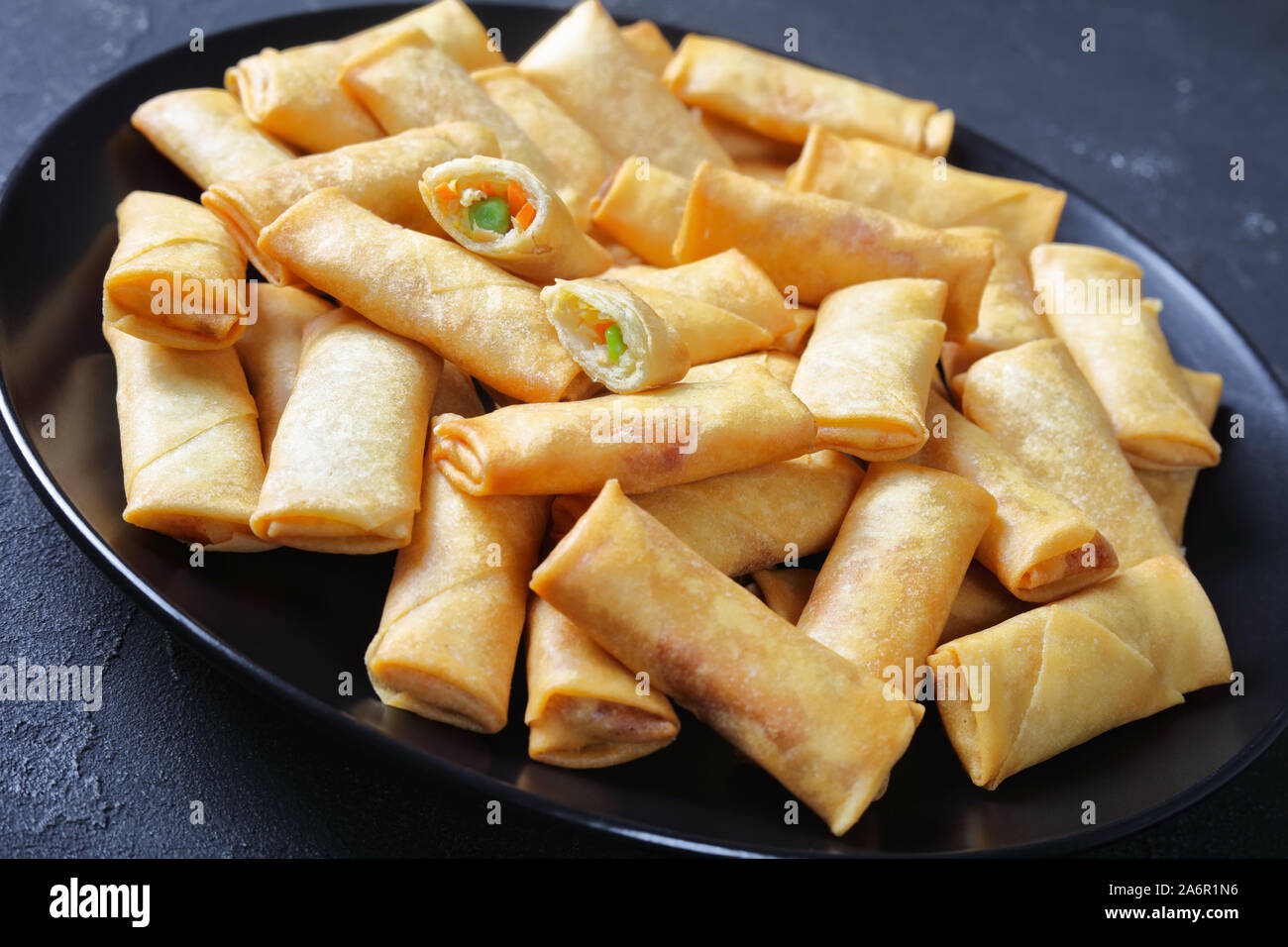 close-up of deep-fried crispy bite-sized chinese spring rolls with ...