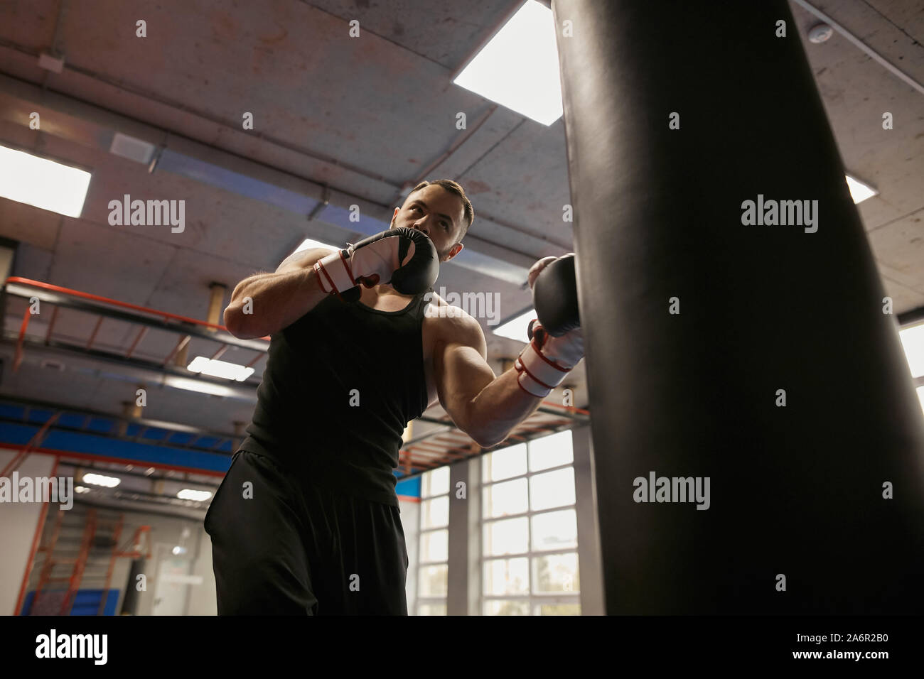 young man in fashion black sportswear leads healthy lifestyle, cross ...