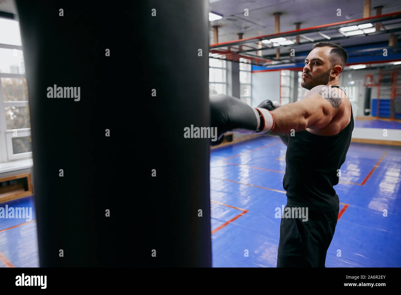 agressive angry fighter reducing stress at gym. close up side view ...