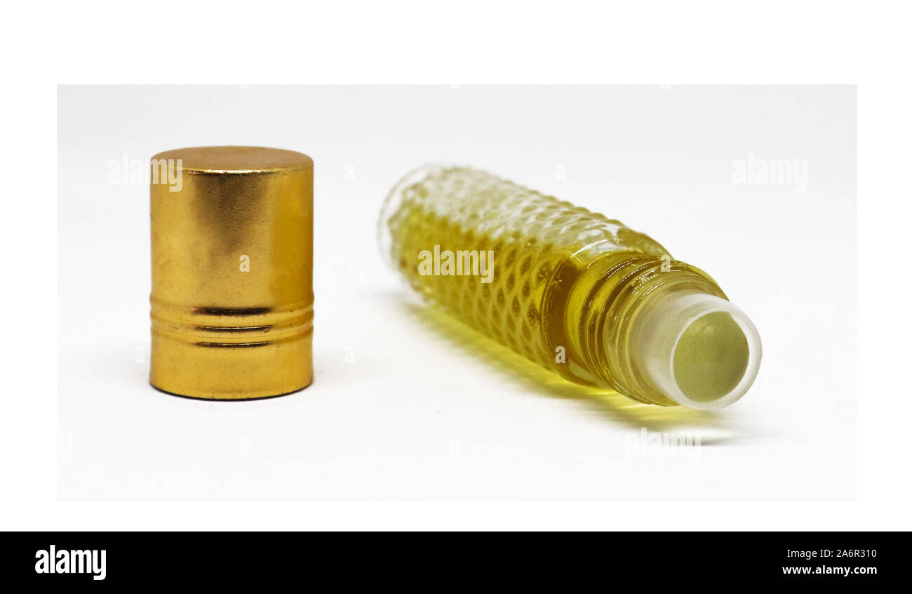 Yellow attar perfume isolated in white background Stock Photo - Alamy