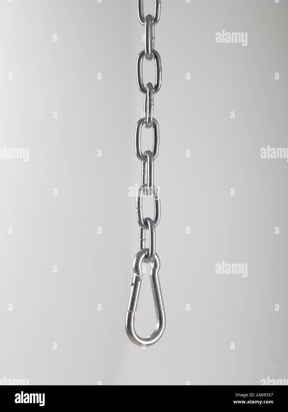 Metallic chain over a white background Stock Photo - Alamy