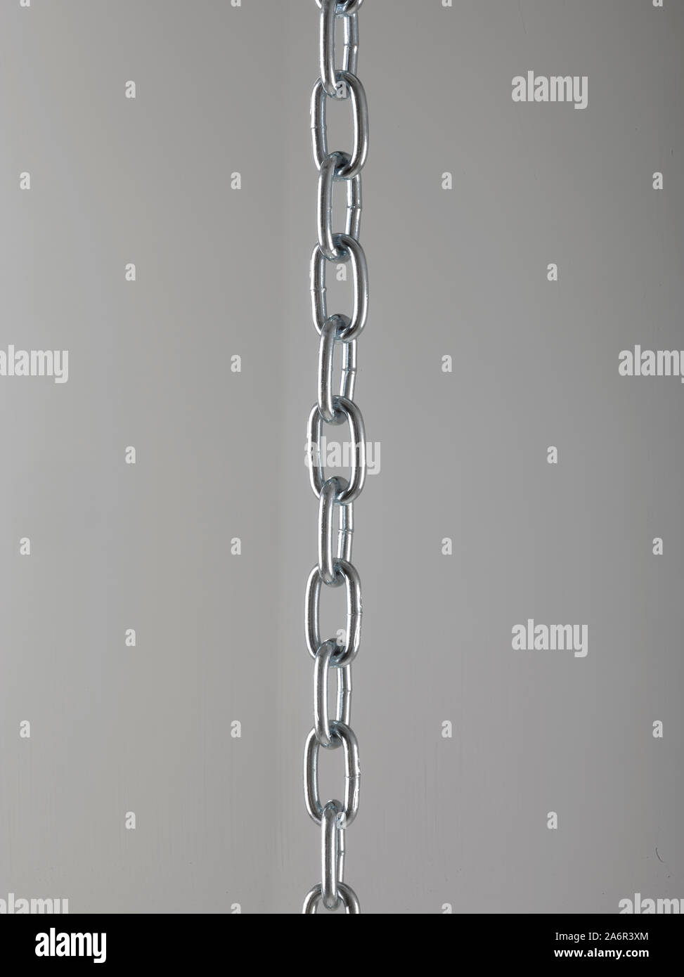 Metallic chain over a white background Stock Photo - Alamy
