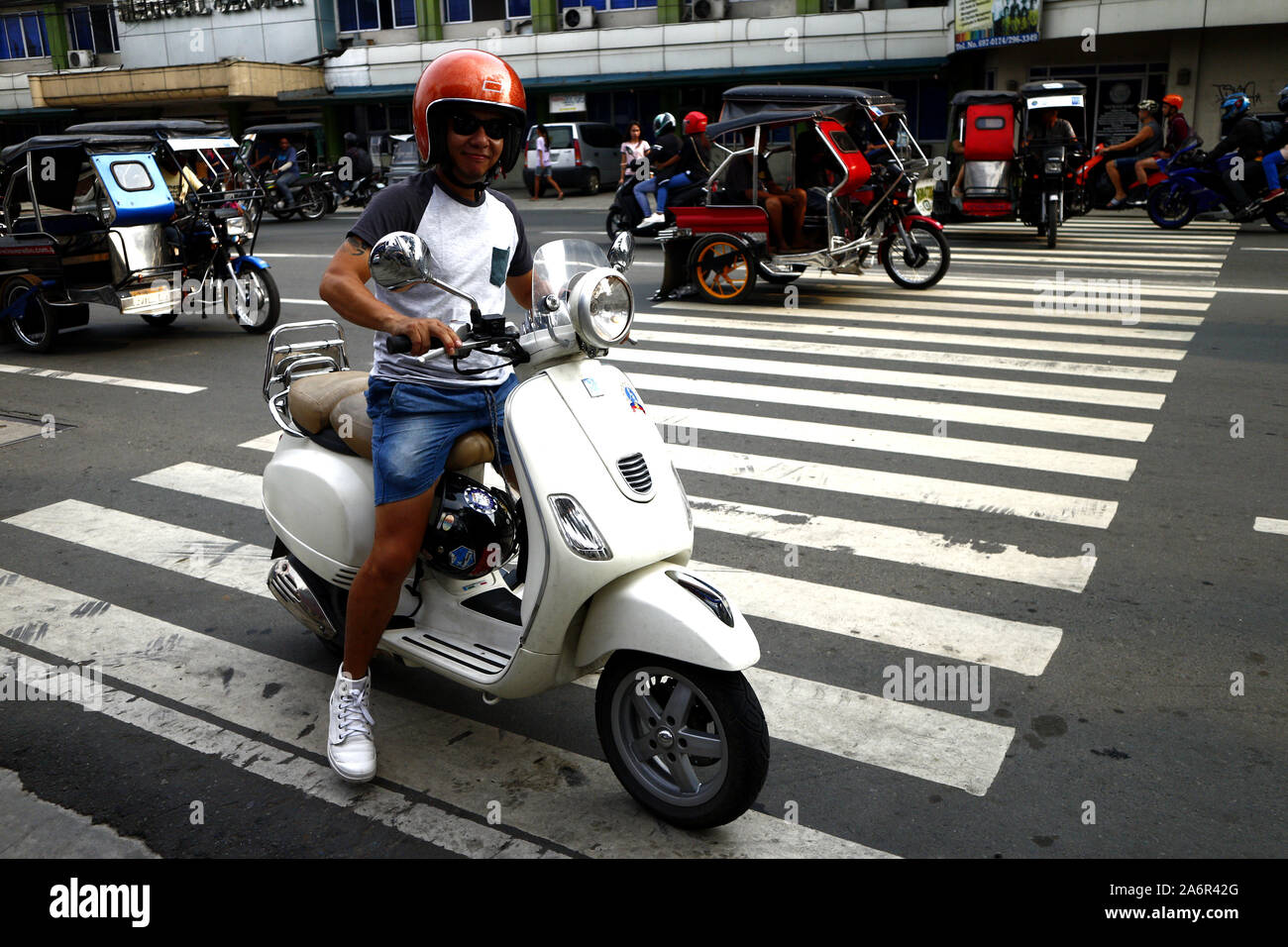ANTIPOLO CITY, PHILIPPINES – OCTOBER 11, 2019: Motorcycle driver stop ...