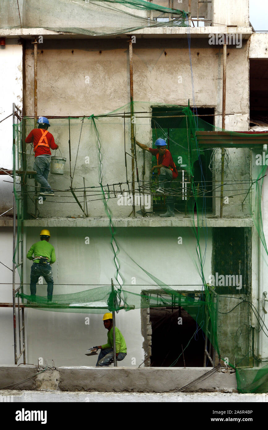 ANTIPOLO CITY, PHILIPPINES – OCTOBER 11, 2019: Construction workers at ...