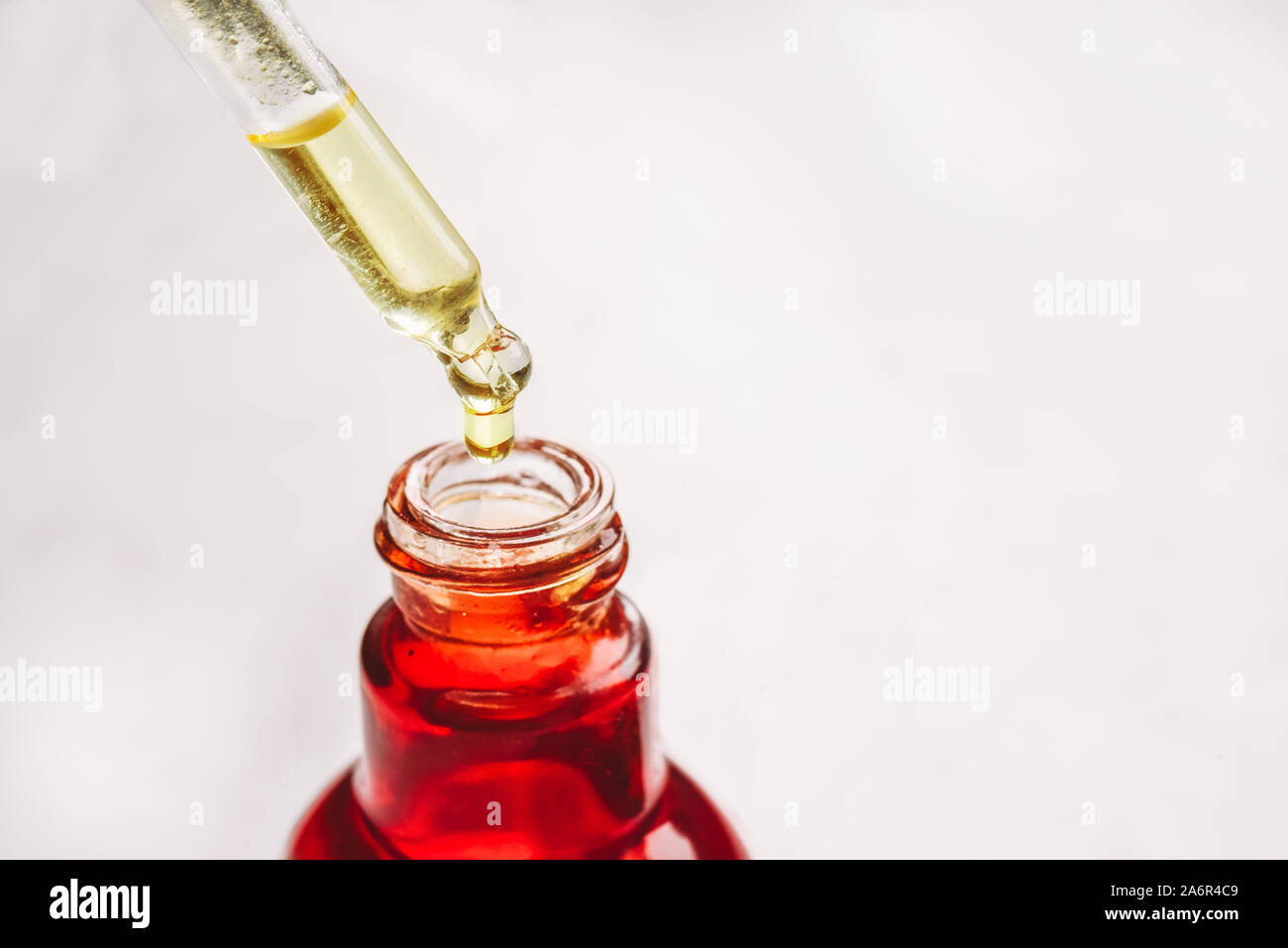 Drop of oil, serum in a dropper closeup. Skin care concept Stock Photo ...