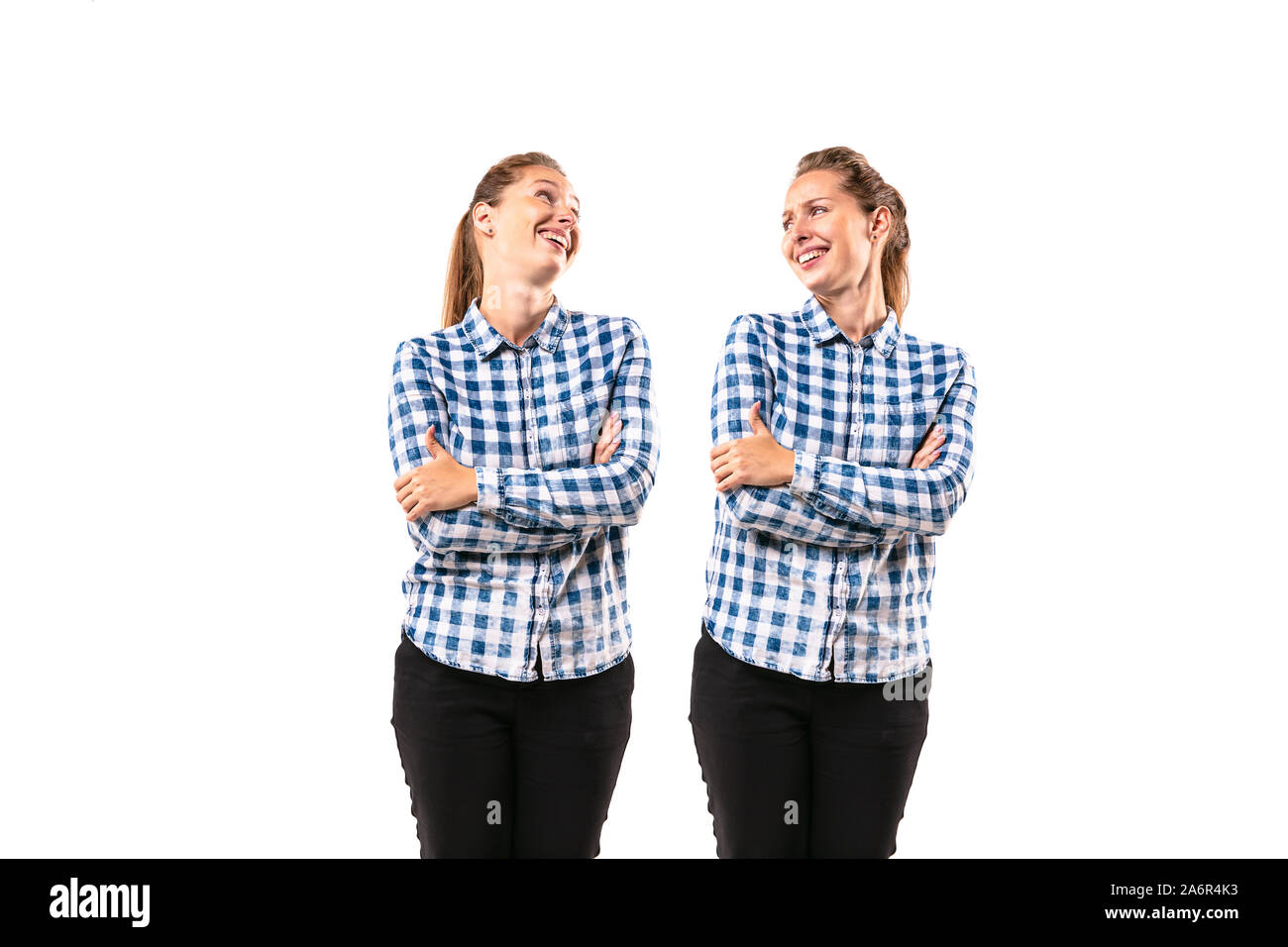 Young handsome woman arguing with herself on white studio background ...