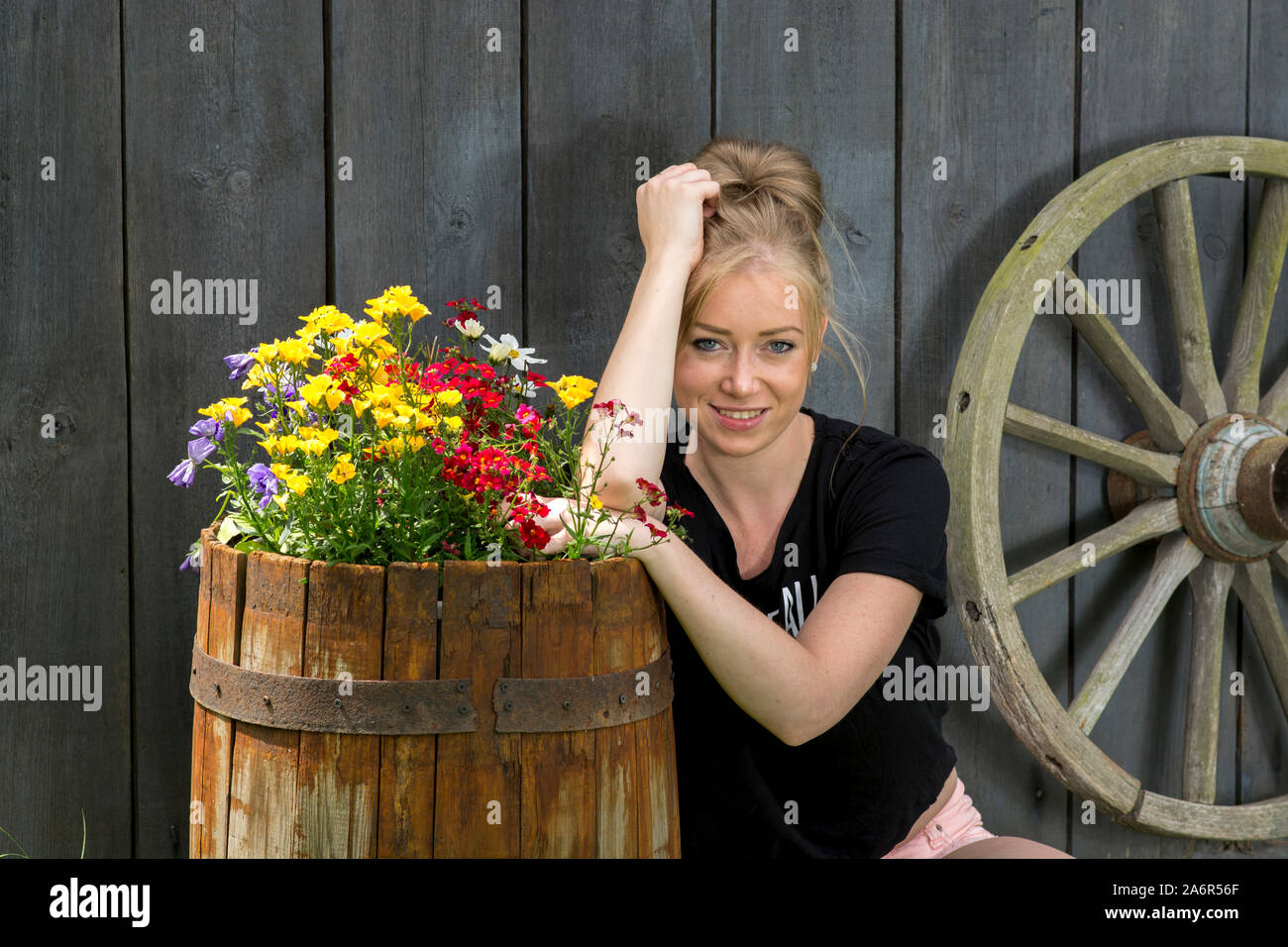 Beautiful girl at an old building with flowers Stock Photo - Alamy