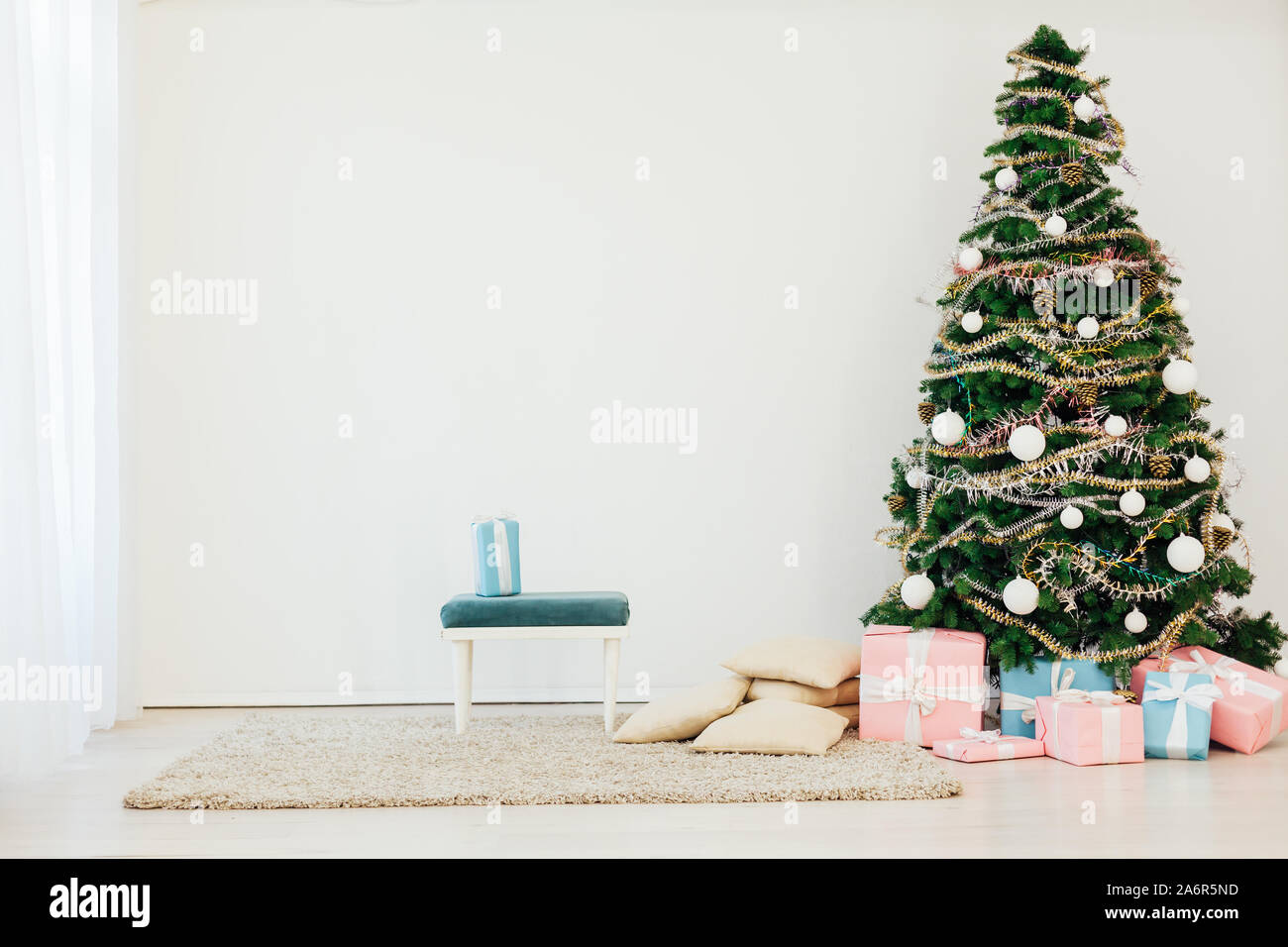Christmas tree with gifts for the new year in the interior of the white ...