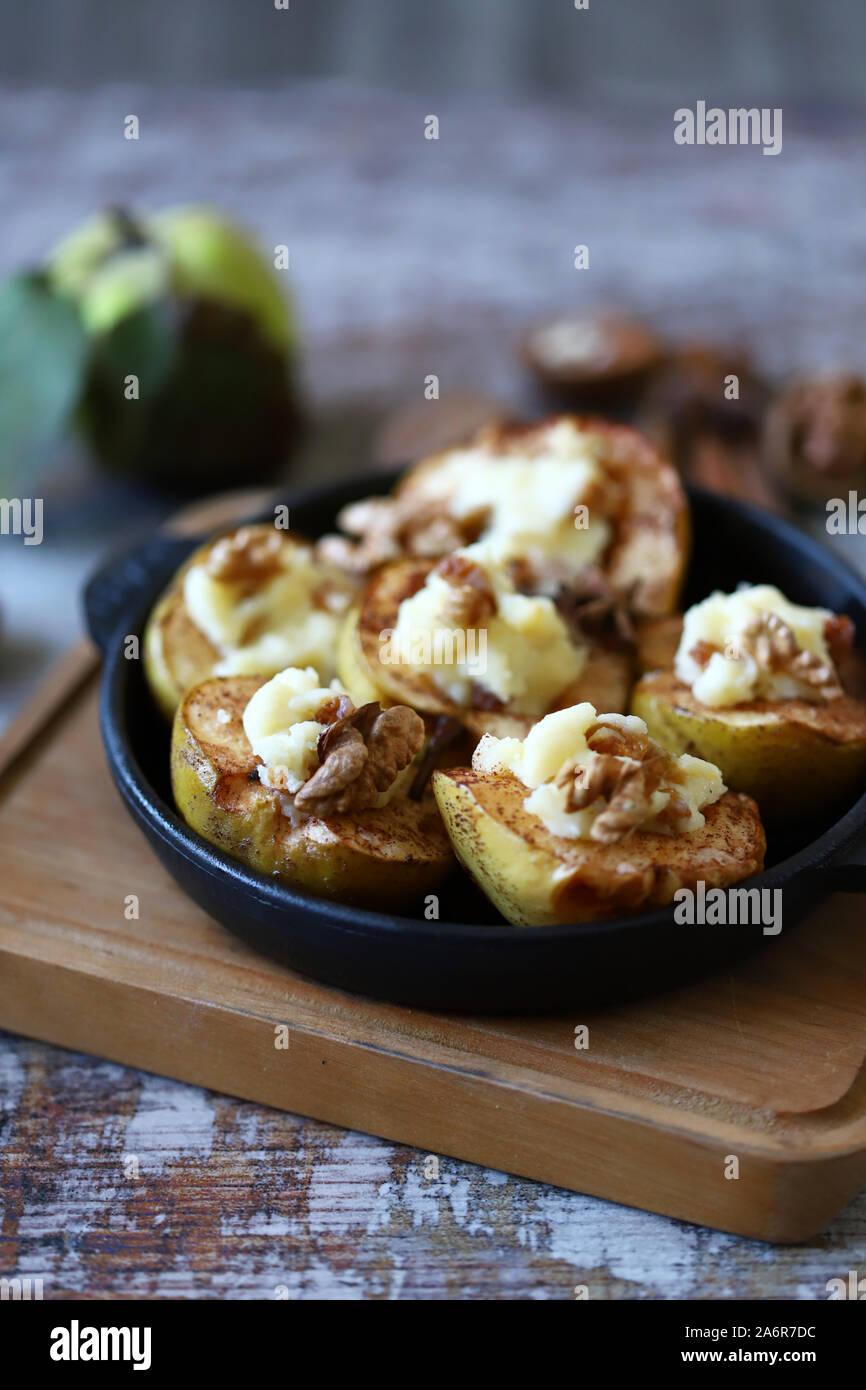 Baked quince with cinnamon and cream cheese. Healthy autumn food. Keto ...
