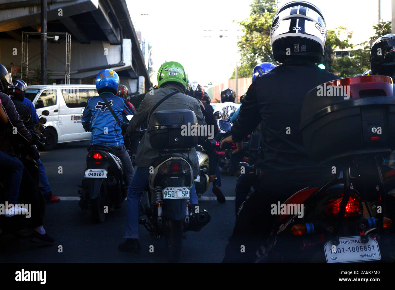 PASIG CITY, PHILIPPINES – OCTOBER 15, 2019: Motorcycle drivers wait for ...