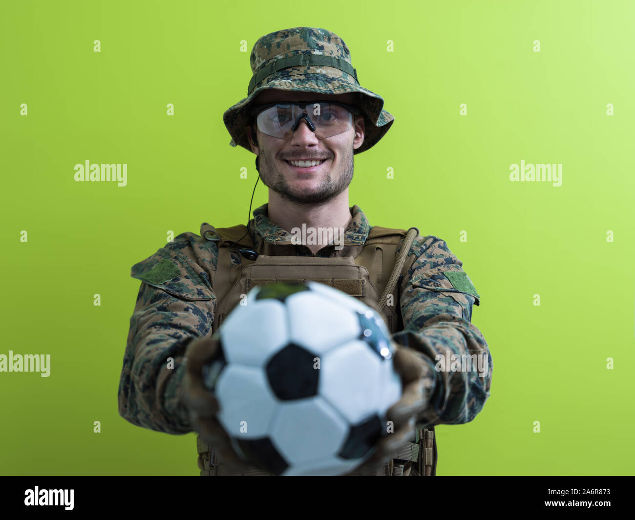 solder holding soccer ball ready for game concept of peace and sport in ...
