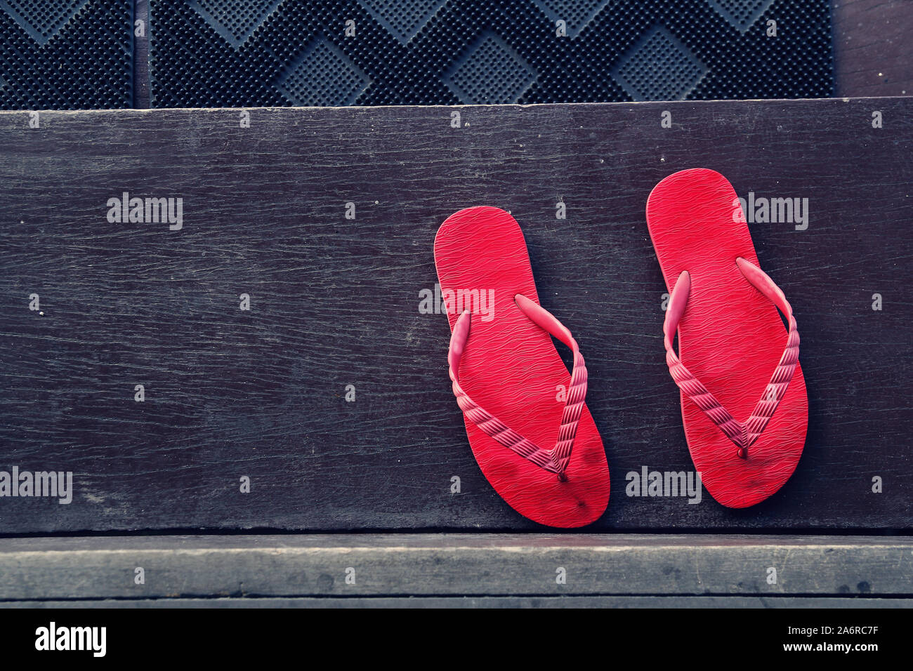 Photo of red rubber slippers at doorstep Stock Photo - Alamy