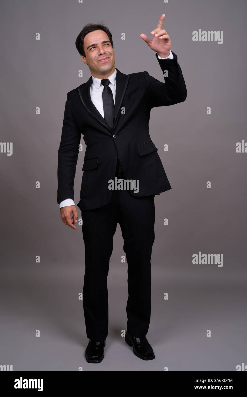 Happy persian businessman pointing up hi-res stock photography and ...