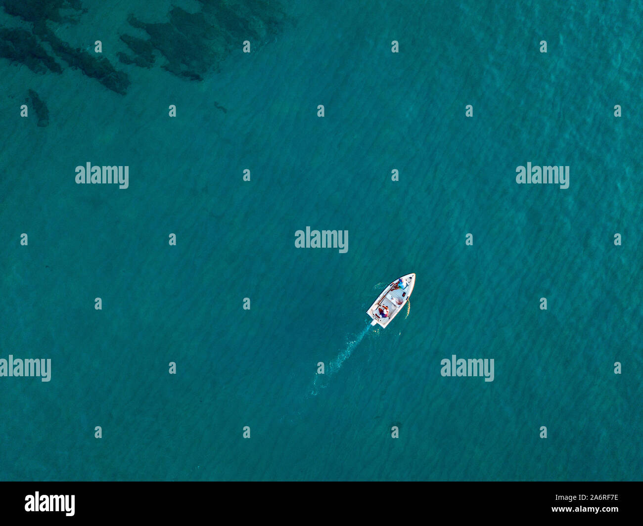 Aerial view of a rowing boat seen from above, powered by an engine ...