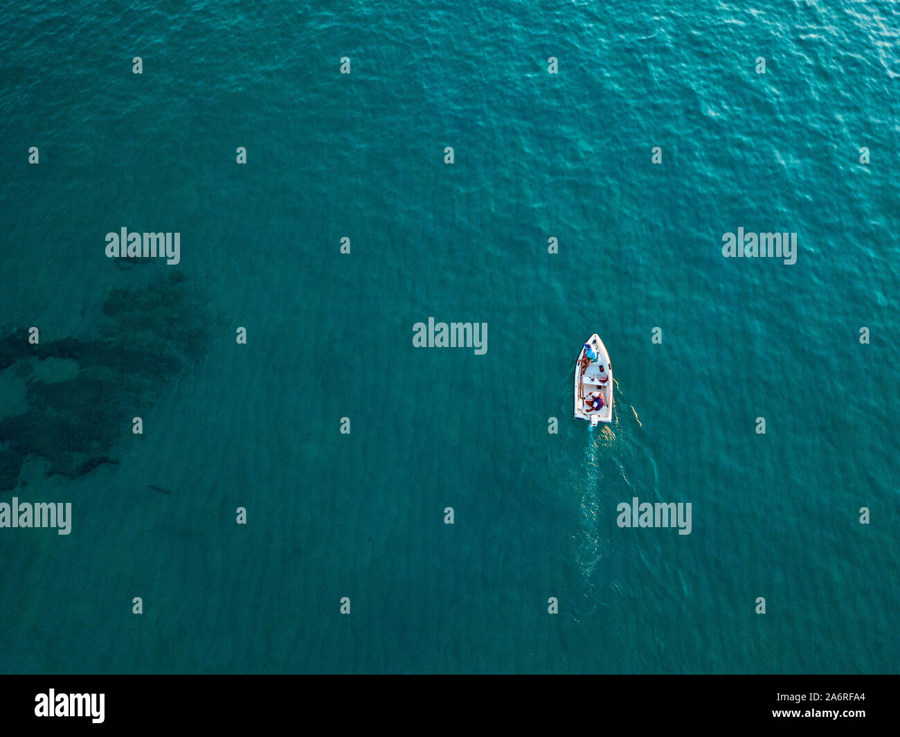 Aerial view of a rowing boat seen from above, powered by an engine ...