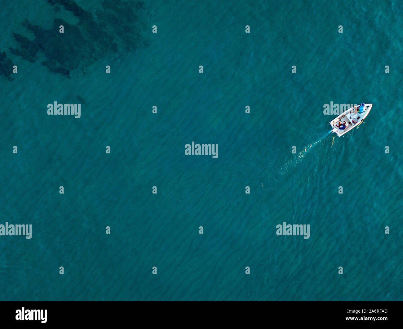 Aerial view of a rowing boat seen from above, powered by an engine ...