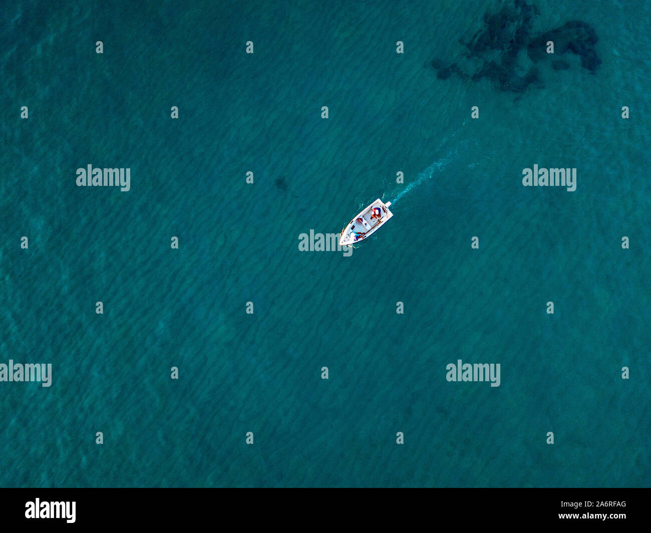 Aerial view of a rowing boat seen from above, powered by an engine ...