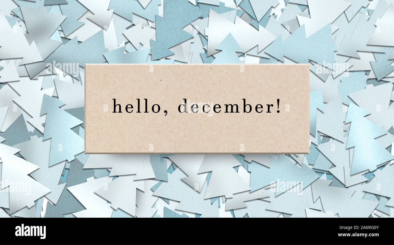 Hello December card on background with Christmas tree shaped confetti ...