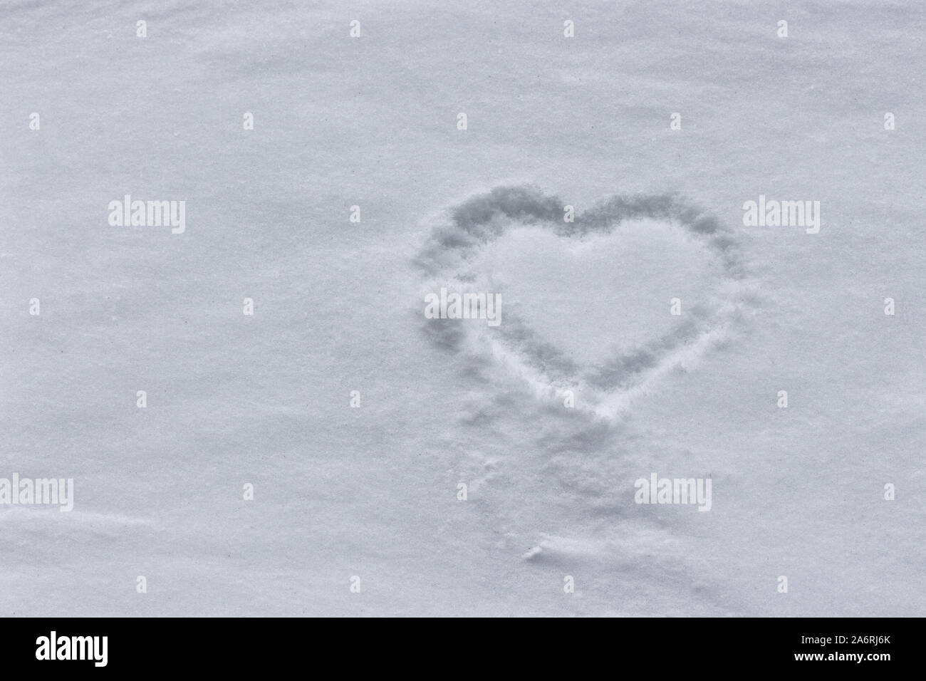 Heart drawing in the snow. Heart shape on fresh pristine snow. Winter ...