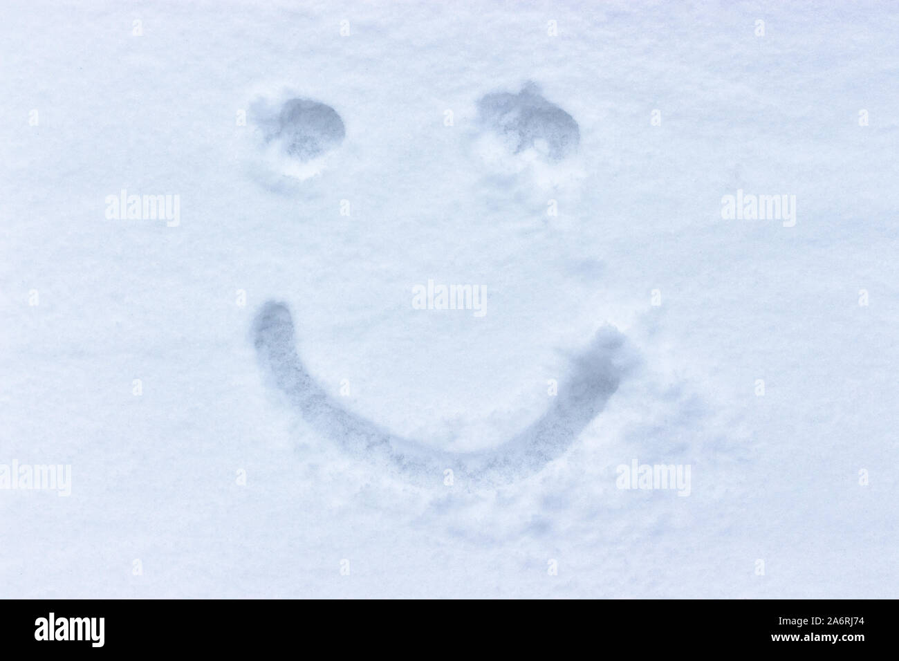 Smiley drawing in the snow. Woman in the fresh, untouched snow. Graza ...