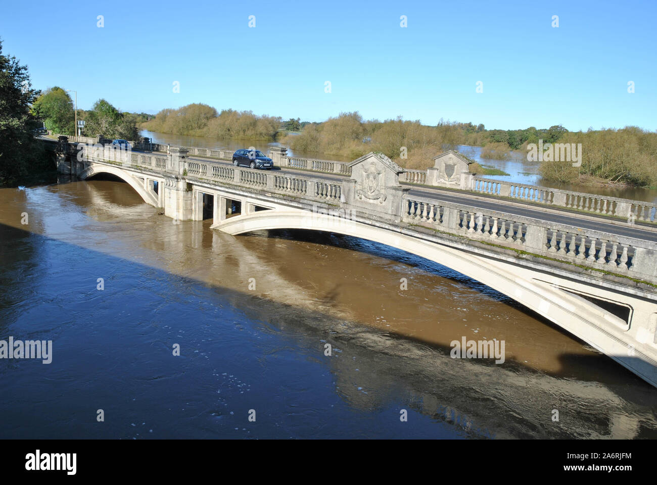 A road bridge at Atcham, Shropshire, UK, showing a flooded and swollen ...