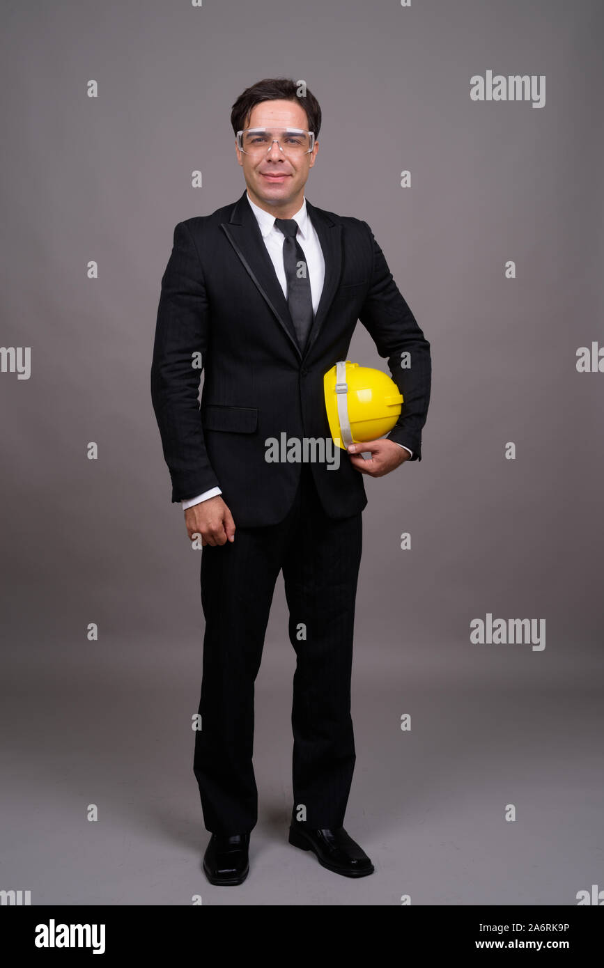 Full body shot of handsome Persian businessman as engineer Stock Photo ...