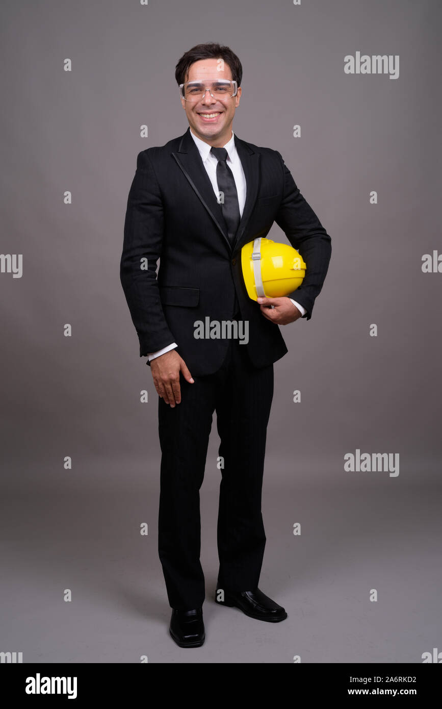 Full body shot of happy handsome Persian businessman as engineer Stock ...