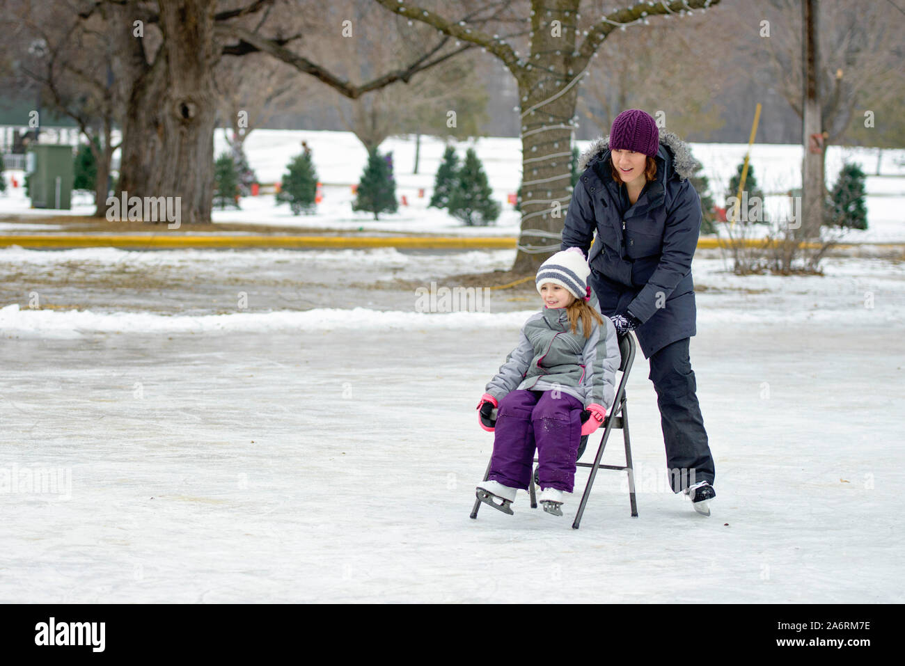 Mother Having Fun Ice Skating With Daughter Stock Photo - Alamy
