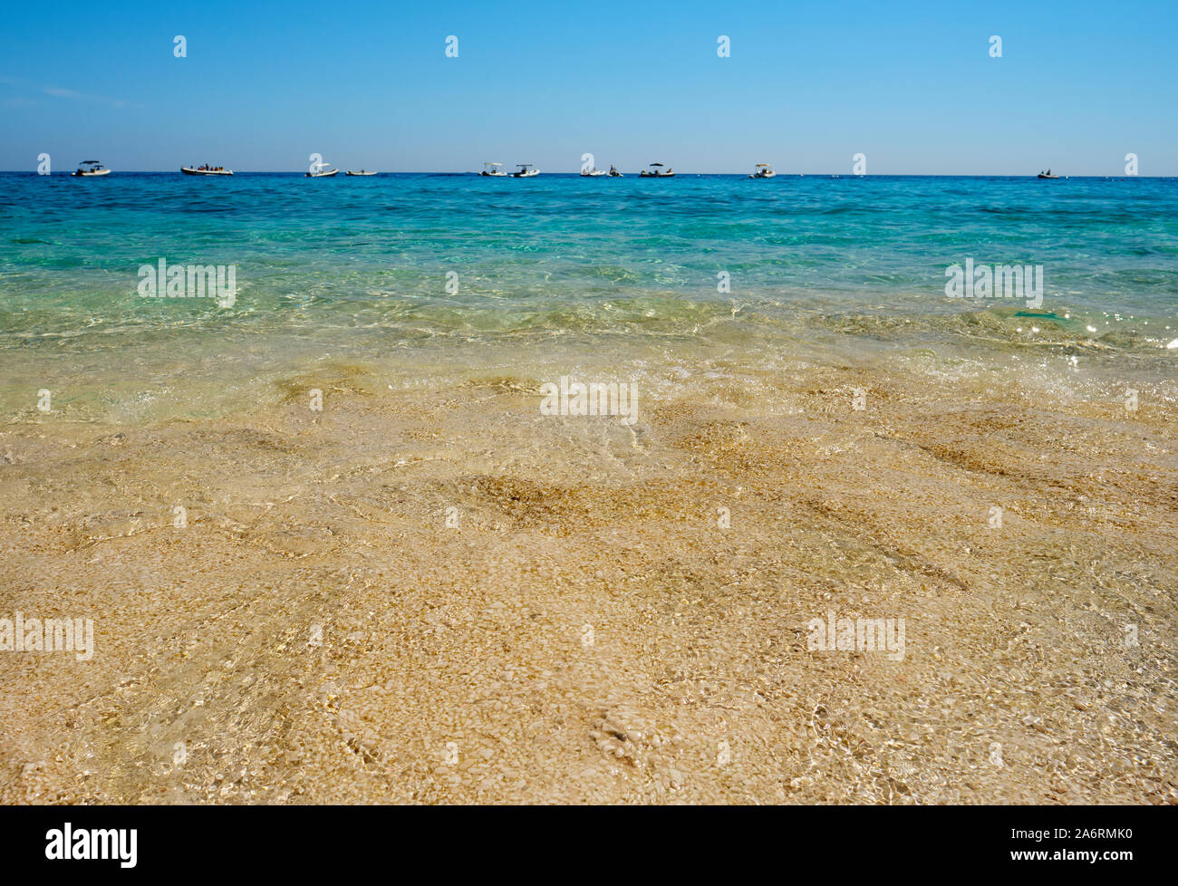 The crystal clear blue sea and white pink sand beach on the Gulf of ...
