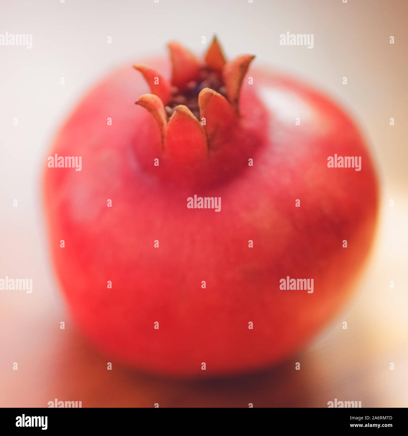 Whole ripe pomegranate close up on the sunny table Stock Photo - Alamy