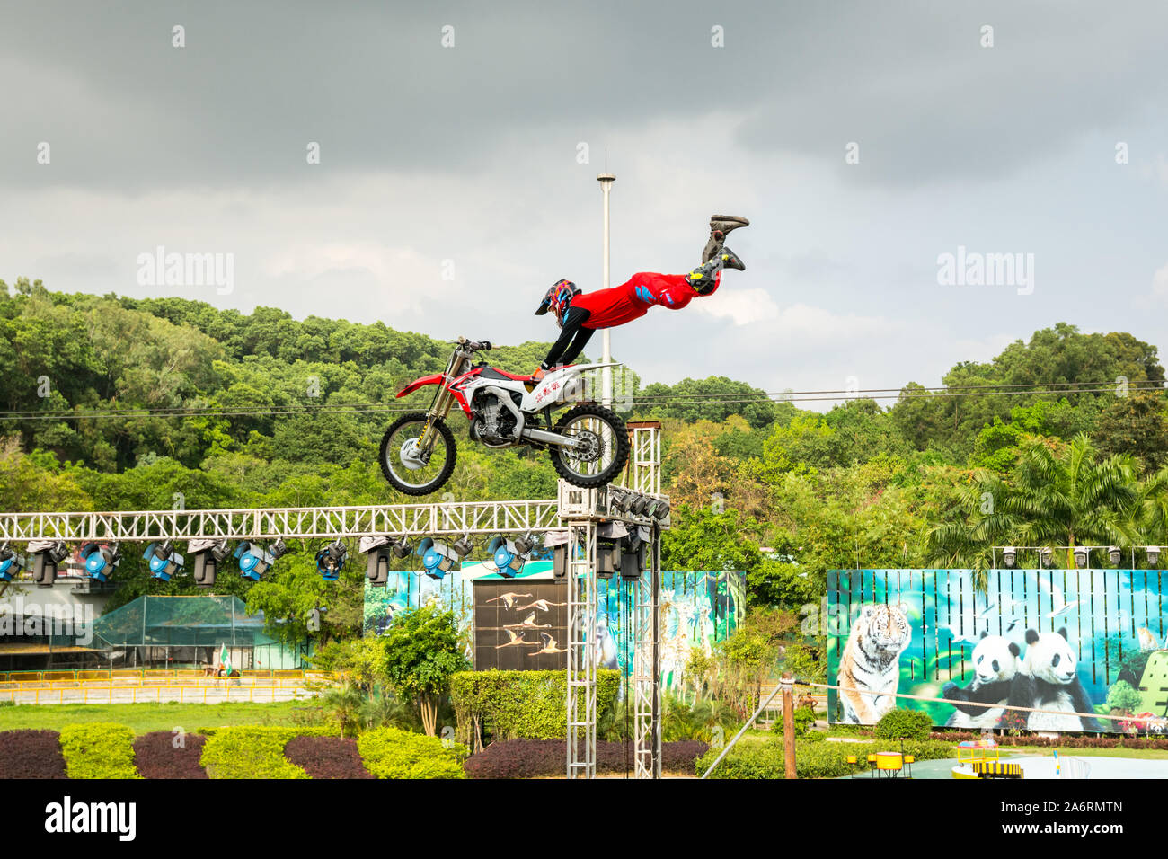 A professional motorcycle rider giving a free style motorcross ...