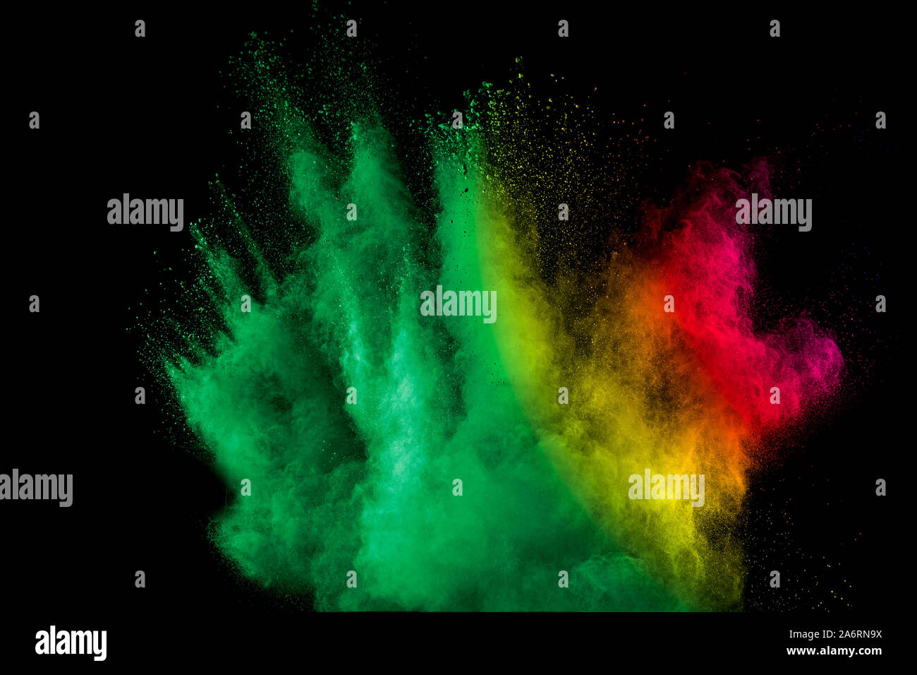 Abstract splash of green colored powder on black background.Green ...