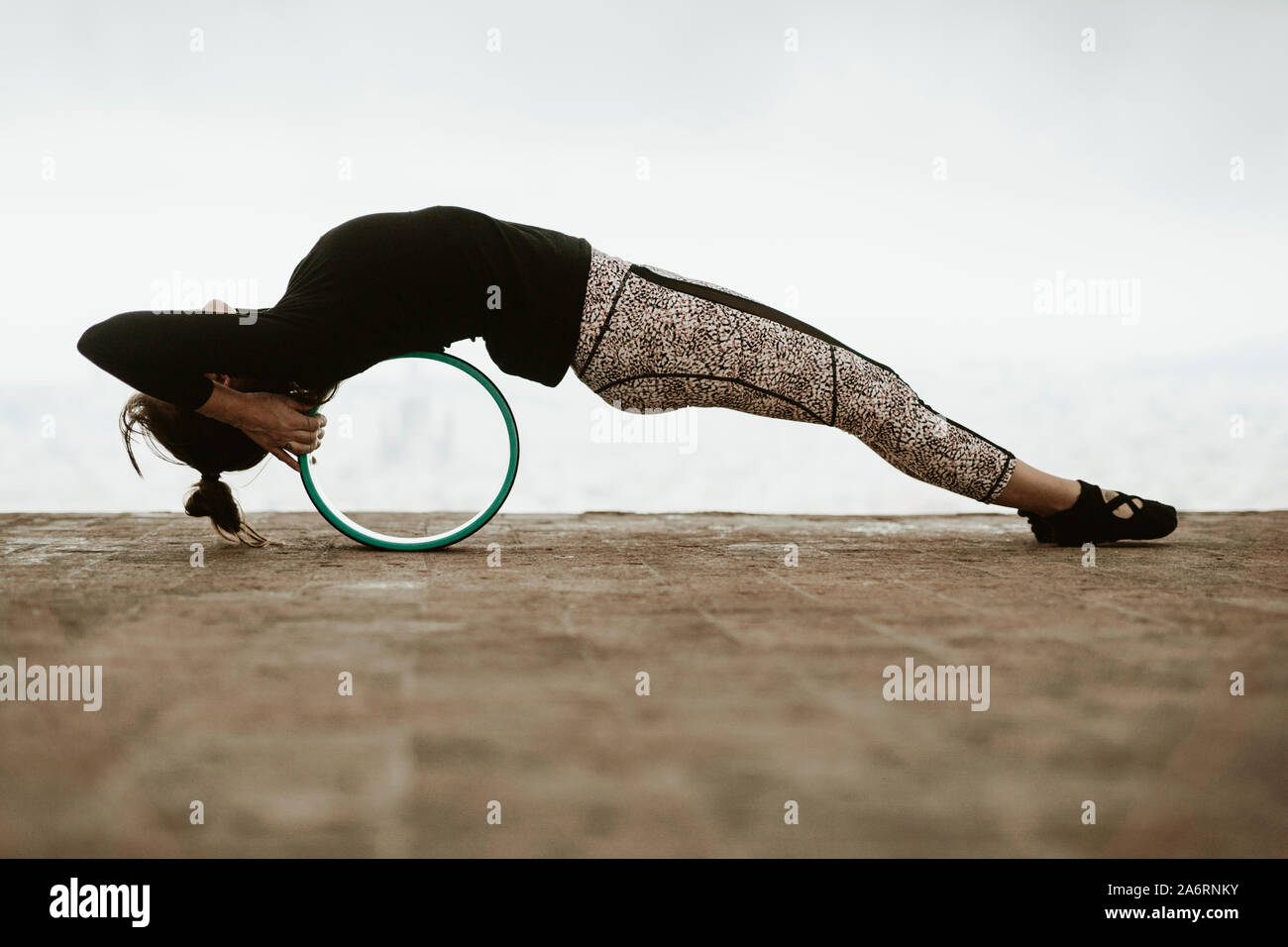 Young woman practicing yoga, stretching her back with a roller Stock ...