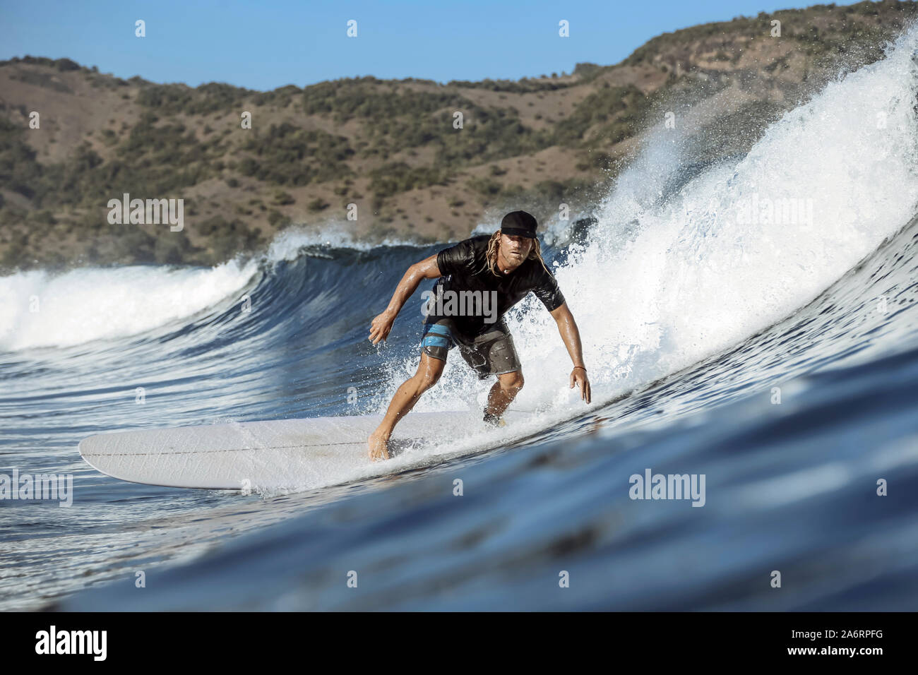 Surfer on a wave Stock Photo - Alamy