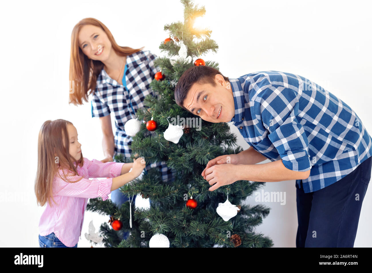 Holidays, parents and celebrating concept - Happy family decorating a ...