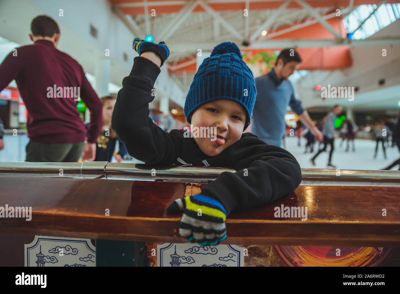 little kid learning how to skate at ice rink Stock Photo - Alamy