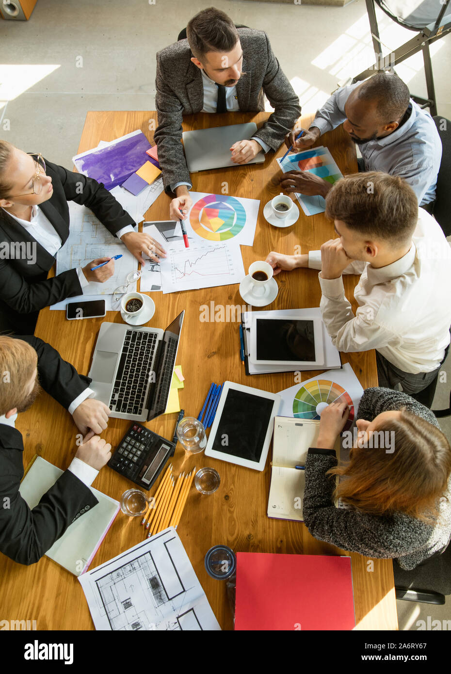 Group of young business professionals having a meeting. Diverse group ...