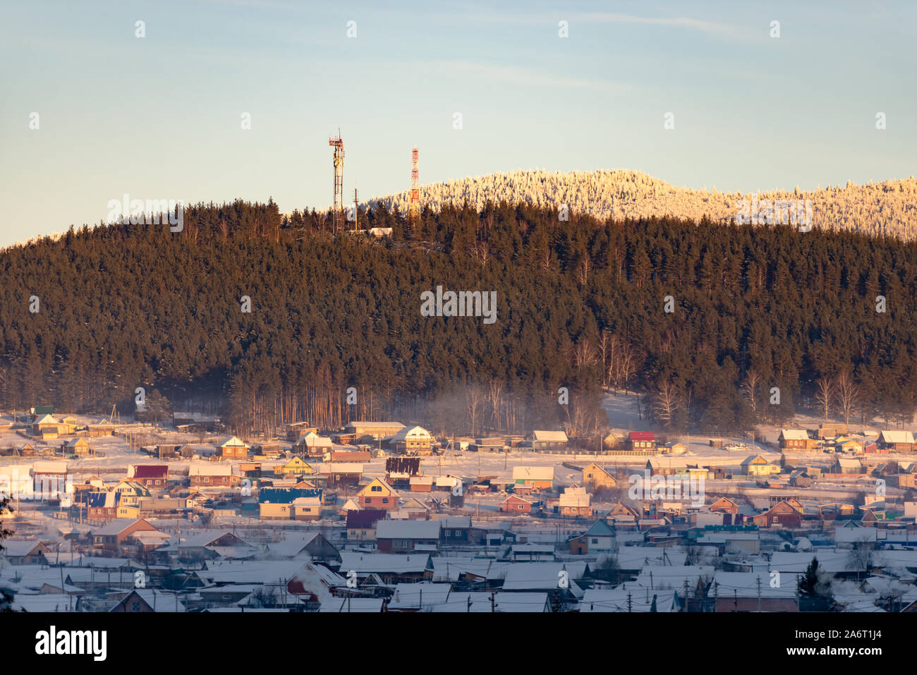 Winter Ural village at sunset. Private houses in the Russian Outback ...