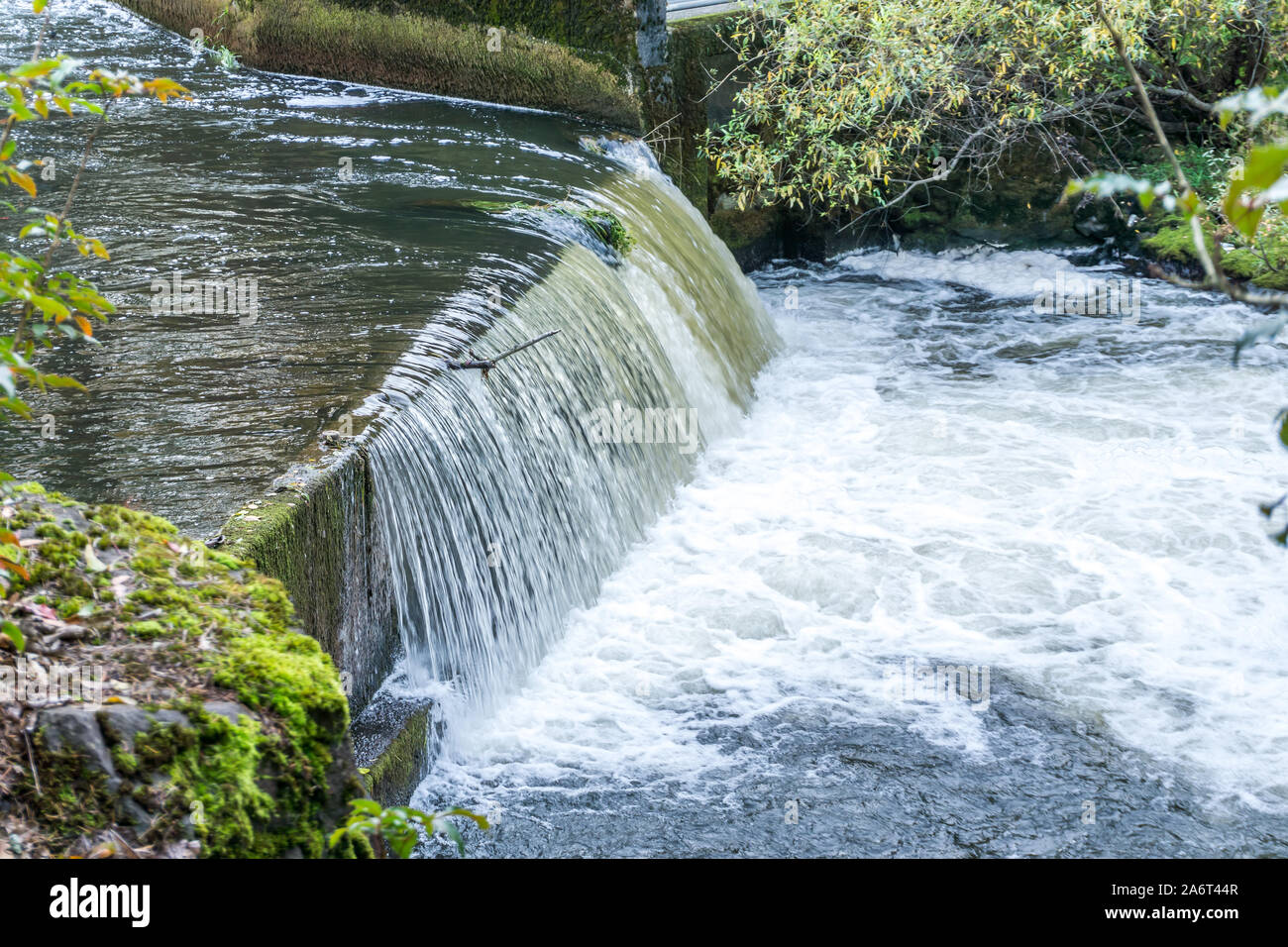 Water flows over a ledge at Tumwater Falls park in Washington State ...