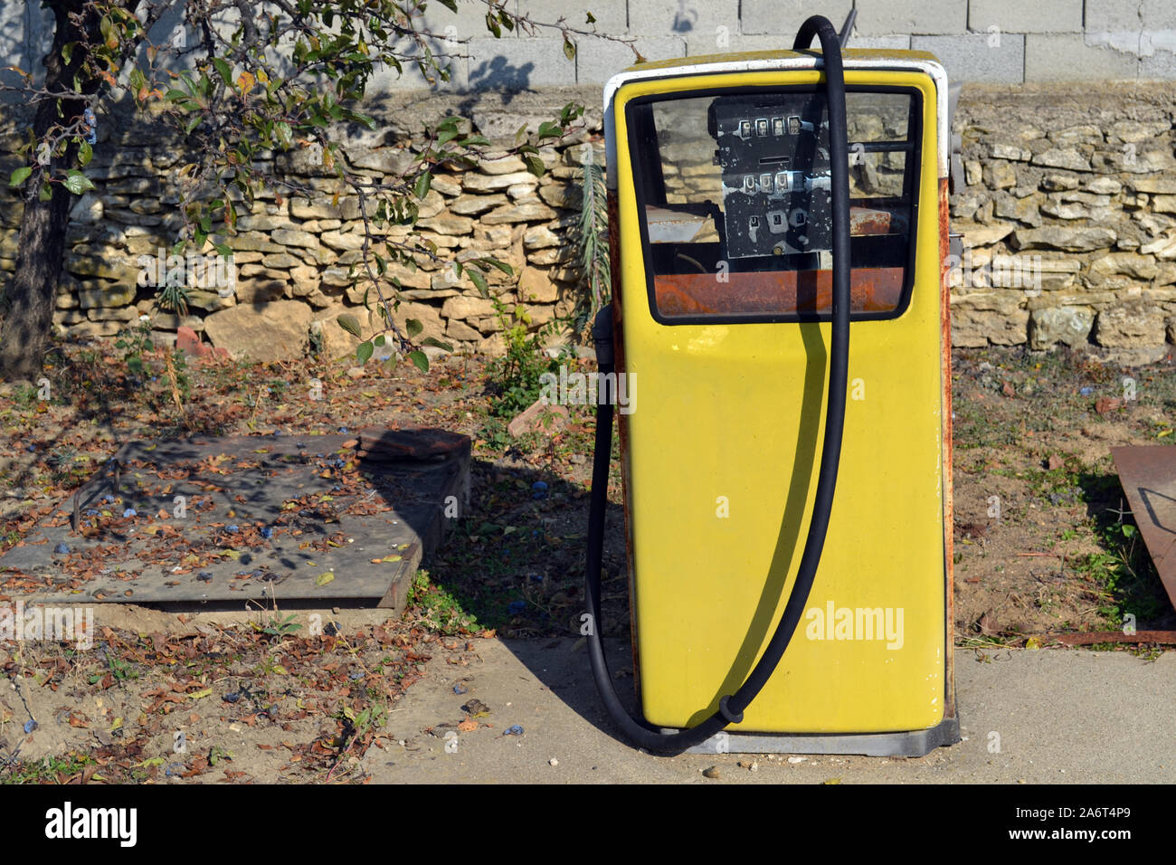 Vintage and rusty gas pumps with black hose Stock Photo - Alamy