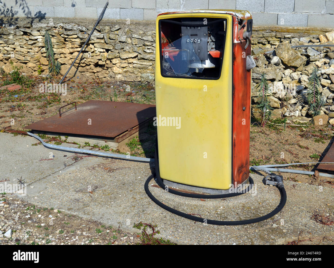 Vintage and rusty gas pumps with black hose Stock Photo - Alamy