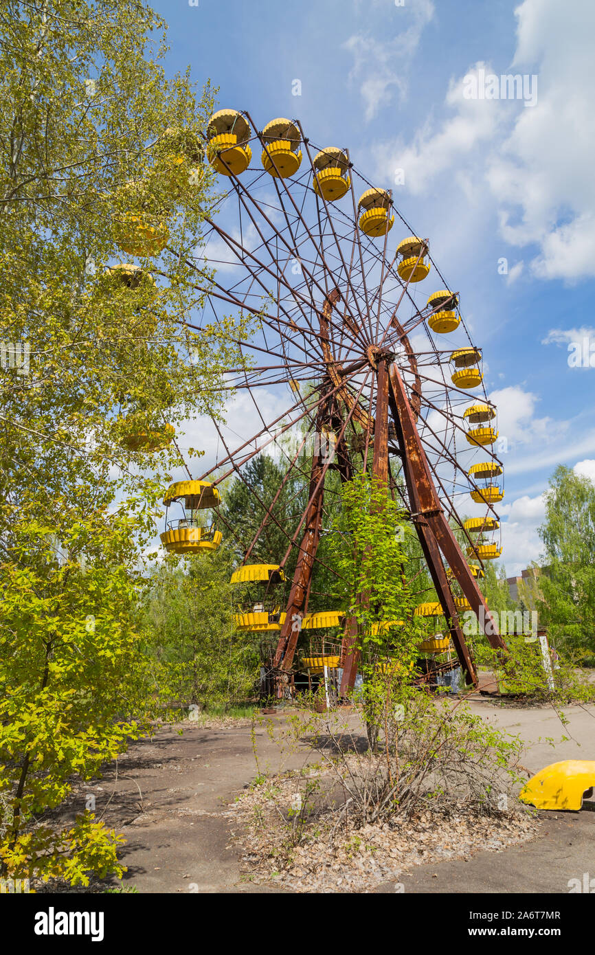 Old broken rusty metal radioactive electric wheel abandoned, the park ...