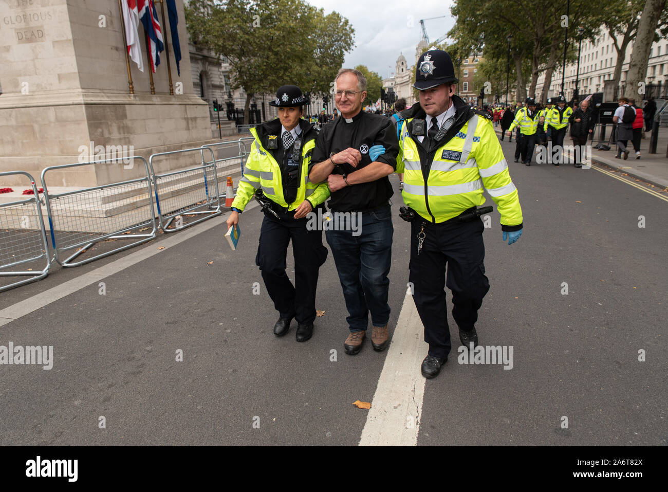 A priest is arrested during an Extinction Rebellion action in ...