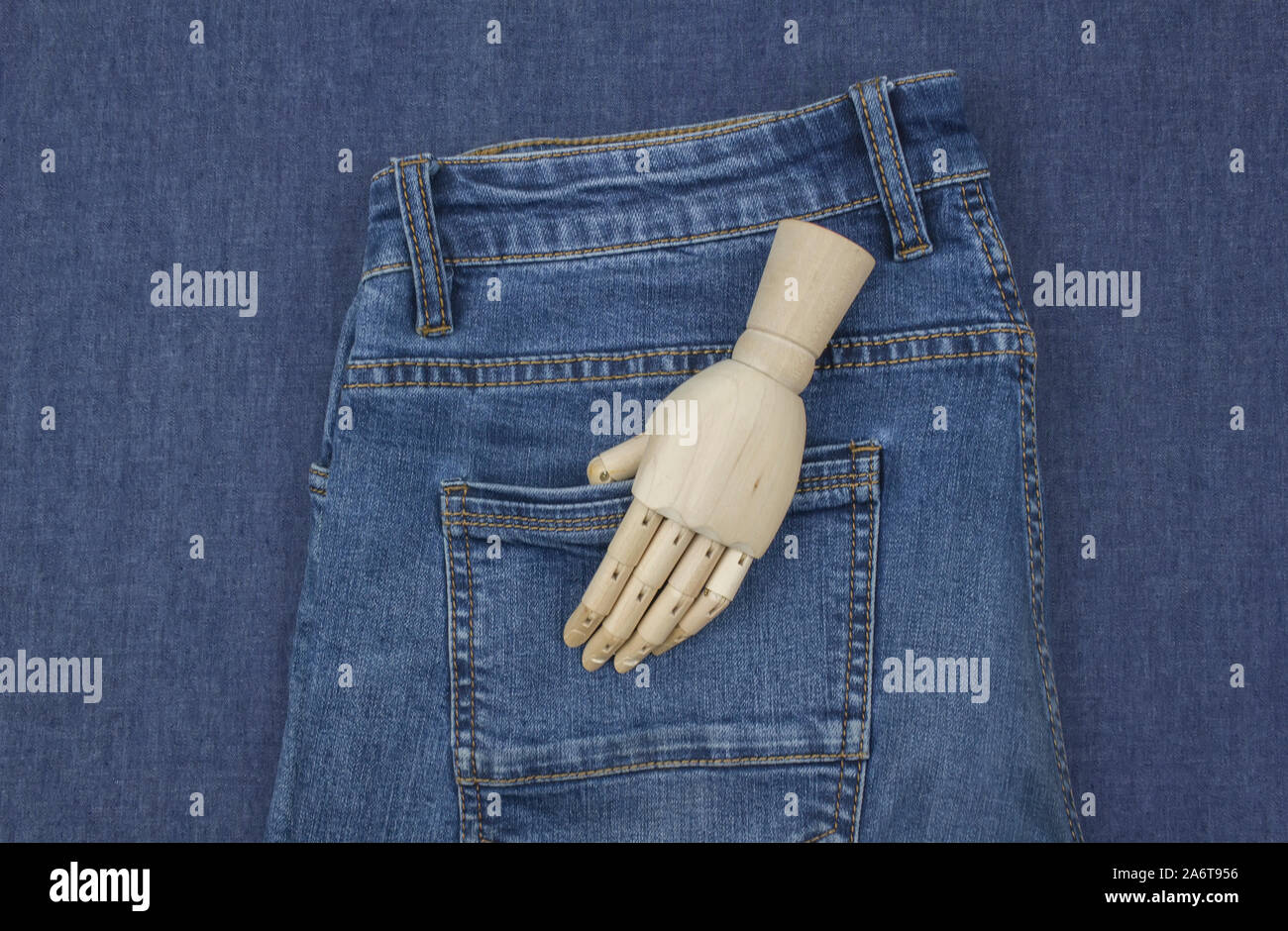 Concept with wooden arm and denim pocket Stock Photo - Alamy