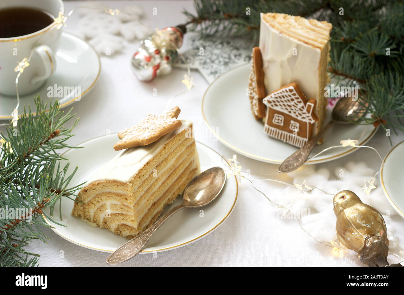 Homemade honey cake with sour cream, decorated with gingerbread. Rustic ...
