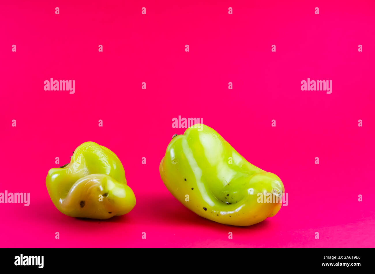 ugly food. green pepper on a red background. copy space Stock Photo - Alamy